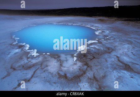 Hot spring Bláhver surrounded by sinter terraces in front of a sunrise ...