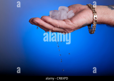 Ice cubes being held in hand and melting Stock Photo - Alamy
