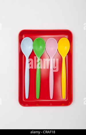 A high-angle view of trays of colorful macarons displayed on a wooden ...