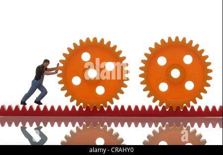Figures with cog wheels Stock Photo - Alamy