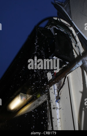 rain overflowing from blocked gutter of pub Stock Photo - Alamy
