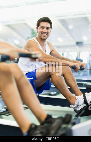 Women using rowing machines in gym Stock Photo - Alamy