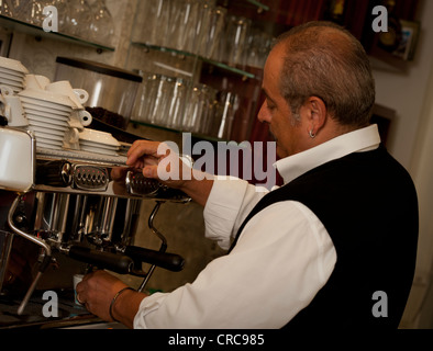 Italian male barista making espresso in his cafe Stock Photo - Alamy