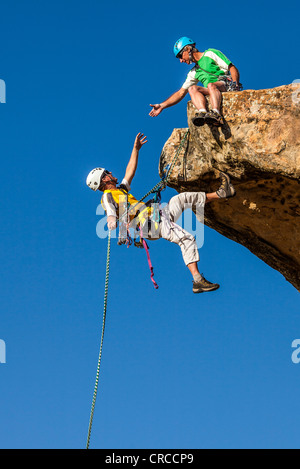 Climbing team struggle to the summit of a challenging rock mountain ...