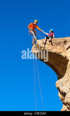 Climbing team struggle to the summit of a challenging rock mountain ...