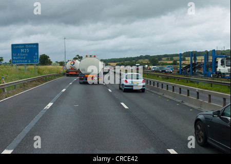 A busy section of the M25, London Orbital Motorway, with a lane closed ...