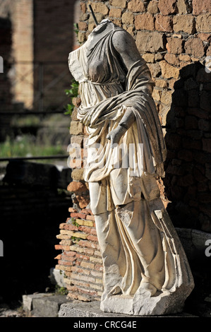Italy, Rome, Ostia Antica, headless roman statue of Cartilius Poplicola ...