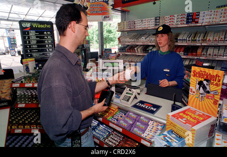 Elf Oil gas station, man refueling Stock Photo - Alamy