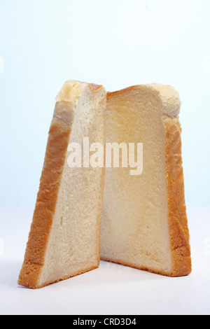 Two pieces of toast standing by leaning on another Stock Photo - Alamy