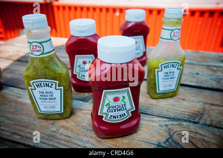 Heinz tomato ketchup bottle, relish and French's mustard on a hamburger ...