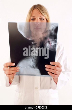 MODEL RELEASED. Doctors looking at an X-ray. Doctors discussing the ...