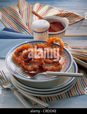 Eating onion rings. Onion ring. Deep fried onion rings. Snack for beer ...
