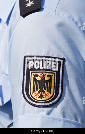 Police badge with federal eagle on sleeve of a blue shirt Stock Photo ...
