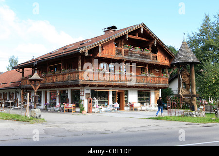 Traditional Bavarian farm house with wooden carved balcony and ...
