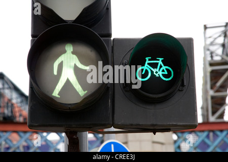 Green man pedestrian and cycle crossing signal at traffic lights in the ...