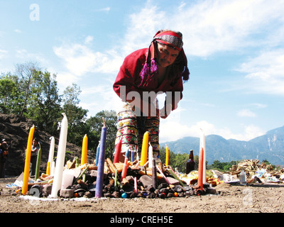 Mayan priests in ritual with Maya altar, burning candles and ...