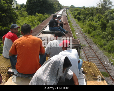 Migrants travel on a freight train, arriving in Ciudad Juarez, Mexico ...