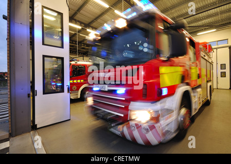 A Moving Fire Engine with Blue Lights On turning out from the station ...