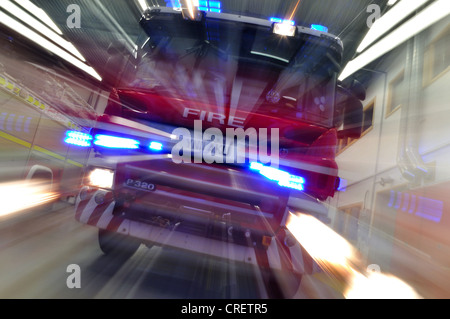 A Moving Fire Engine with Blue Lights On turning out from the station ...