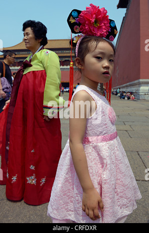 CHINA BEIJING Young Chinese mother prepares to put newspaper down so ...