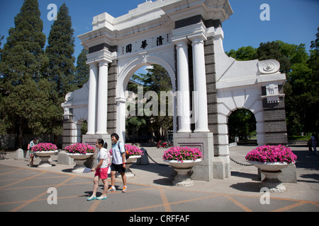 Students pass by The Old Gate on campus at Tsinghua University in ...