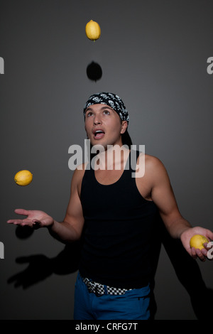 Young man juggling isolated on white background Stock Photo - Alamy