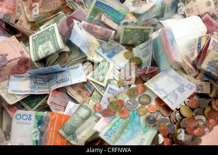 Variety of different bank notes and coins from various countries like ...
