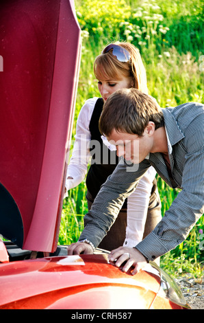 woman looking at car engine road assistance Stock Photo - Alamy