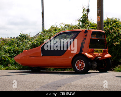 Side view of an Orange Bond Bug, converted into an EV, on display at ...