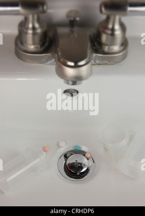 In the sink drain someone has thrown drugs and pills Stock Photo - Alamy