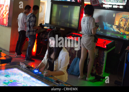 Amusement gaming entertainment arcade with shoppers, in Beijing, China ...