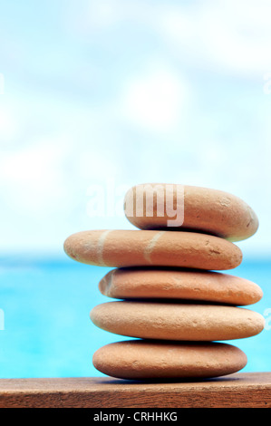 balancing beach pebbles or stones with the sea in the background Stock ...
