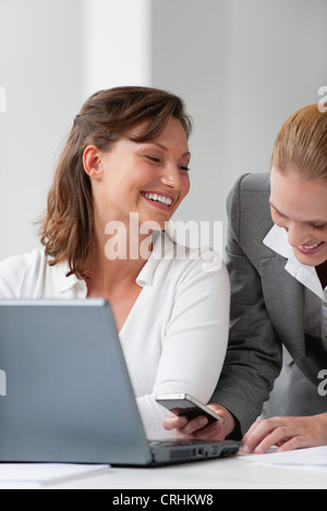 partial view of woman using smartphone with blank screen on sandy beach ...