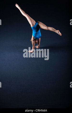 Gymnast doing handstand with legs split Stock Photo - Alamy