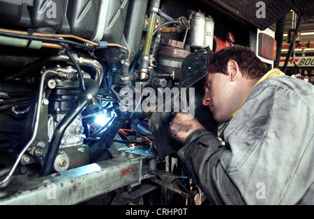 Bochum, Germany, car mechanic repairs engine Stock Photo - Alamy