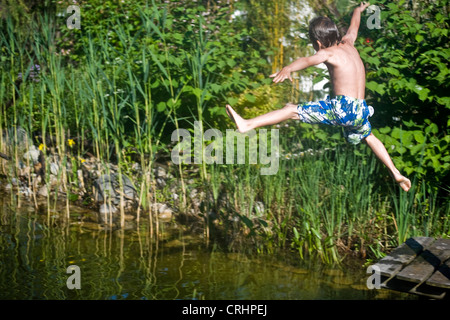 Children jump in to a pond to cool off during a hot day About 330 Stock ...