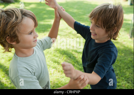 Two kids as friends fighting with each other for fun Stock Photo - Alamy