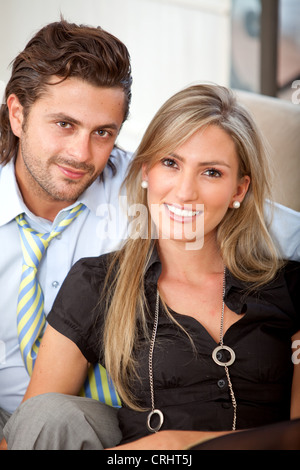 A Hispanic elegant male with long hair buttoning his suit isolated on ...