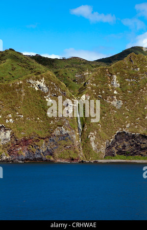 Waterfall and narrow rocky beach on Inaccessible Island, South Atlantic ...