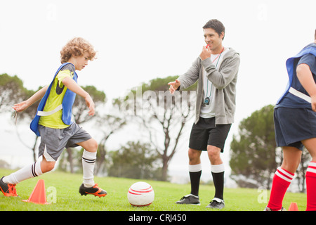Football coach coaching children. Soccer football training session for ...