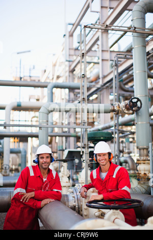 Two Smiling Oil Refinery Workers in Personal Protective Equipment with ...