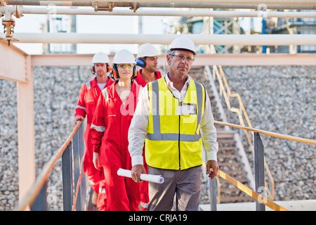 Workers walking at chemical plant Stock Photo - Alamy