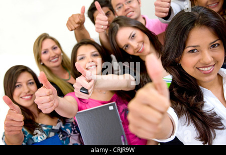 group of smiling students showing thumbs up Stock Photo - Alamy