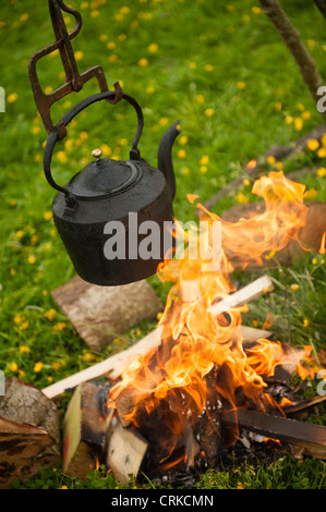 Kettle Boiling over open fire In The woods Stock Photo - Alamy