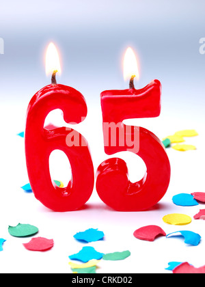 Number 65 birthday celebration candle against a bright yellow Stock ...