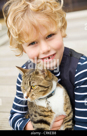 Portrait of boy holding cat , outside.With MR Stock Photo - Alamy