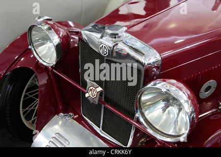 Headlights and radiator grill of an MG classic car on display at a ...