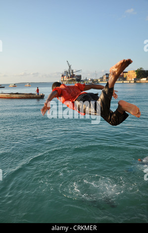 African boys diving in Stone town, zanzibar Stock Photo - Alamy