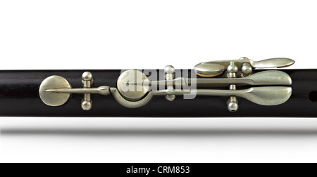 Detail of disassembled metal flute isolated on dark table illuminated ...