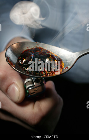 man cooking up drugs on a spoon with a lighter Stock Photo - Alamy
